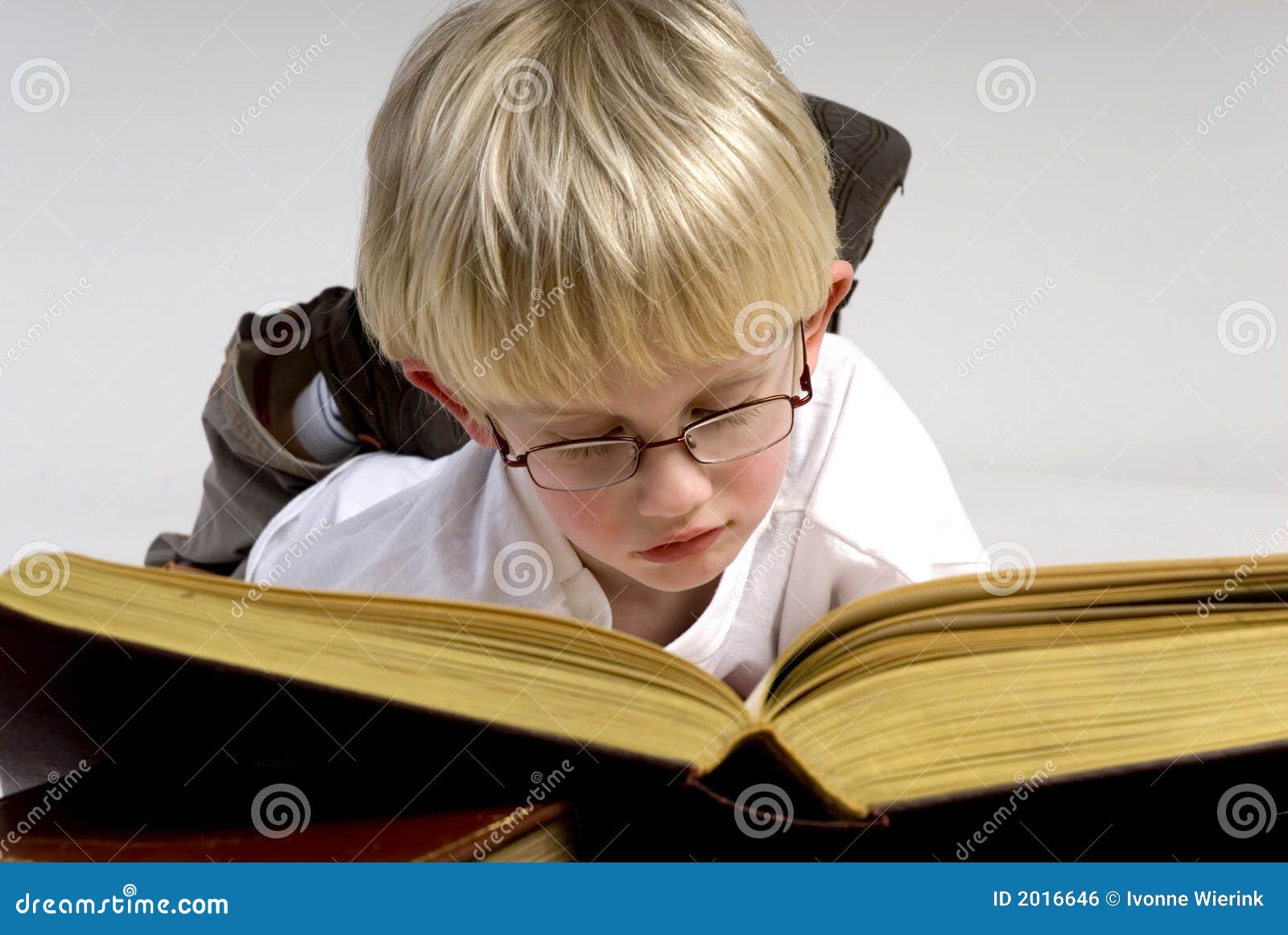 Boy is reading thick books stock photo. Image of glasses - 2016646