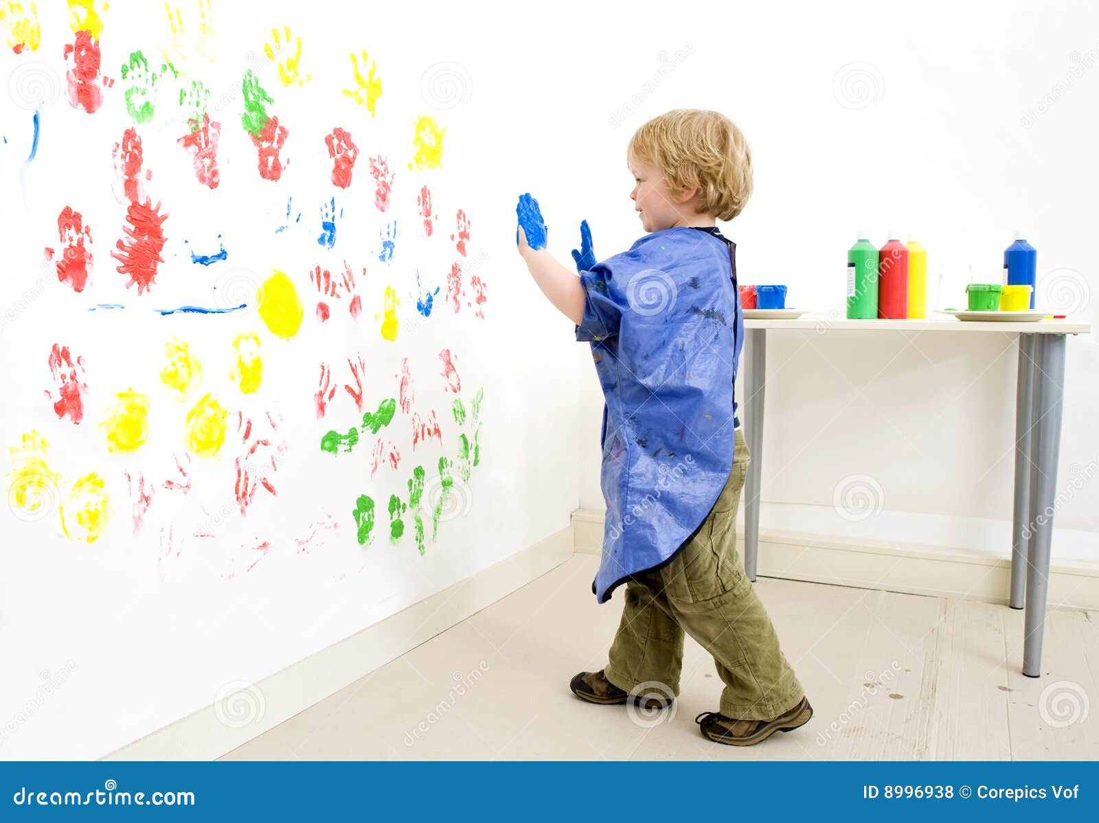 Boy ready to fingerpaint stock photo. Image of naughty - 8996938