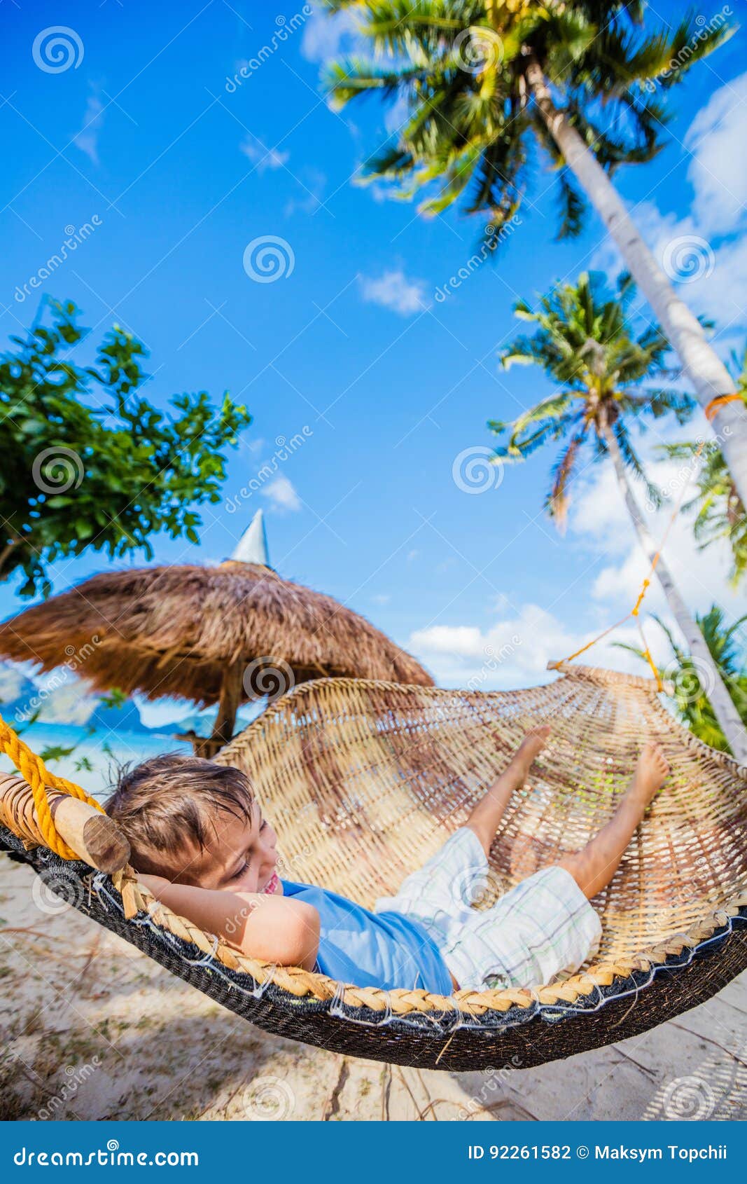 Boy relaxing on a beach. stock photo. Image of ocean - 92261582
