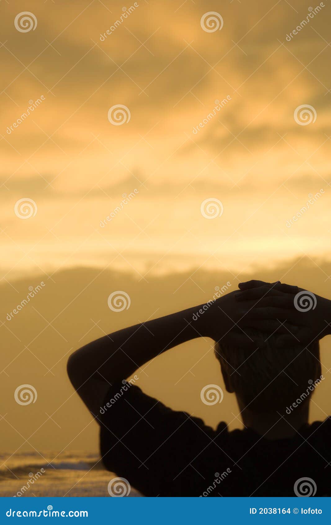 Boy Relaxing on Beach at Sunset Stock Photo - Image of silhouette ...