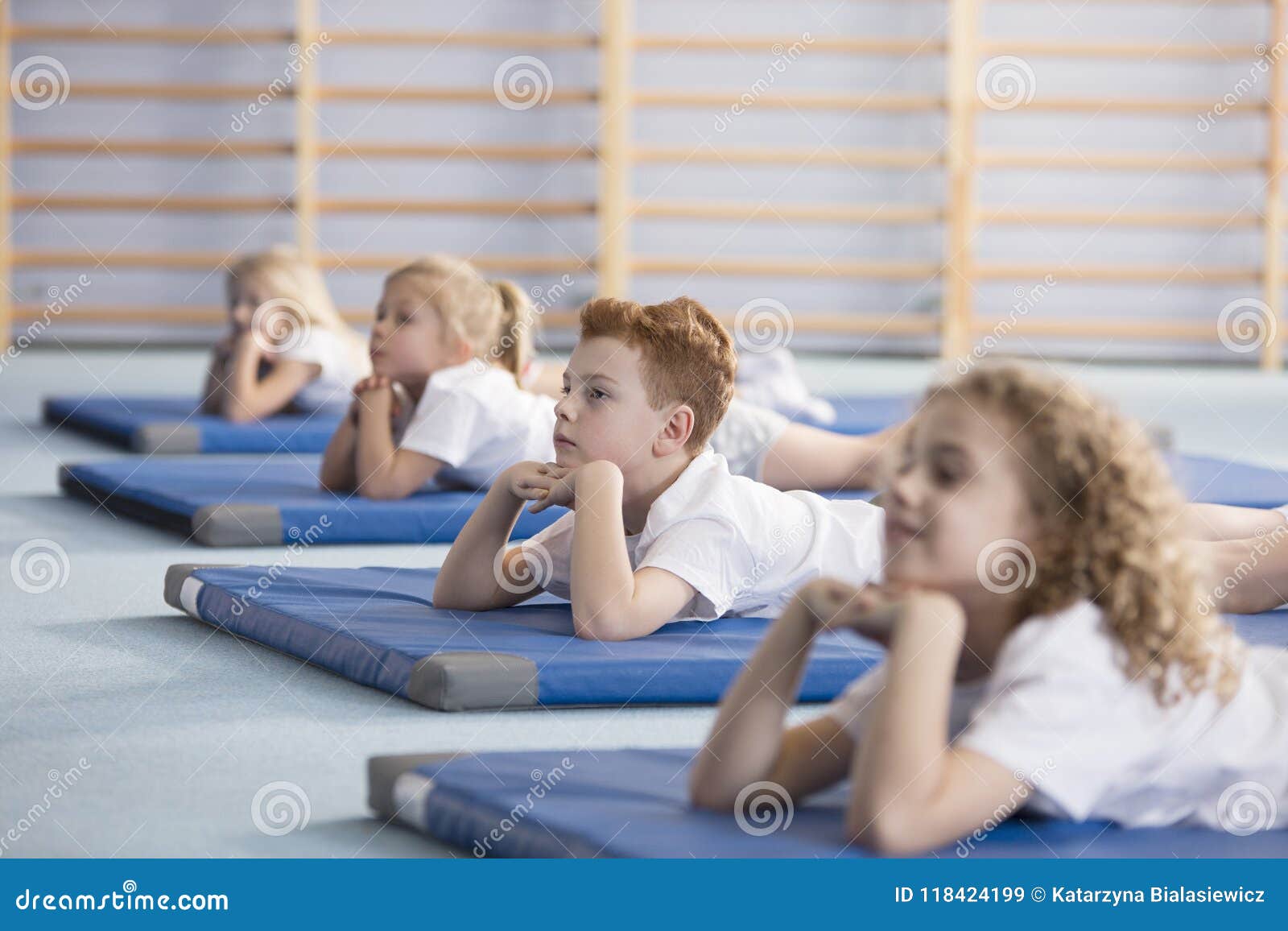 Boy relaxing on blue mat stock image. Image of education - 118424199