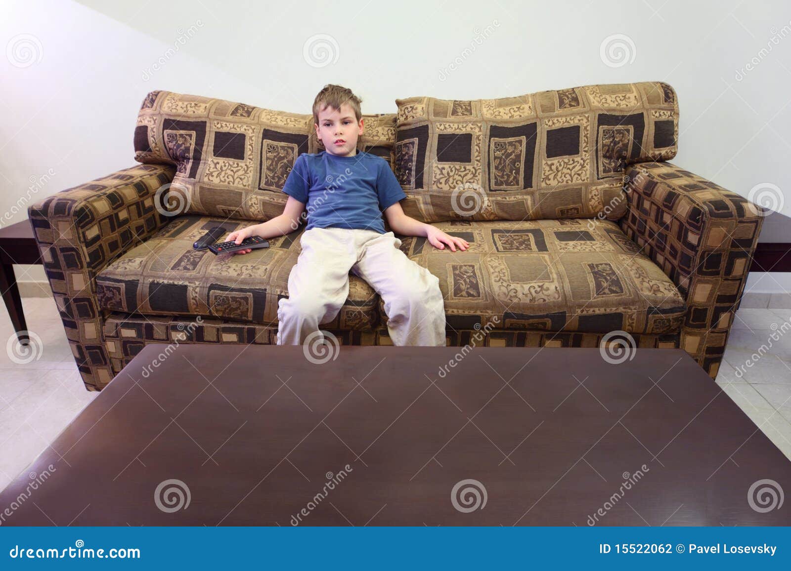 Boy with Remote Control Sitting at Sofa in Room Stock Photo - Image of ...