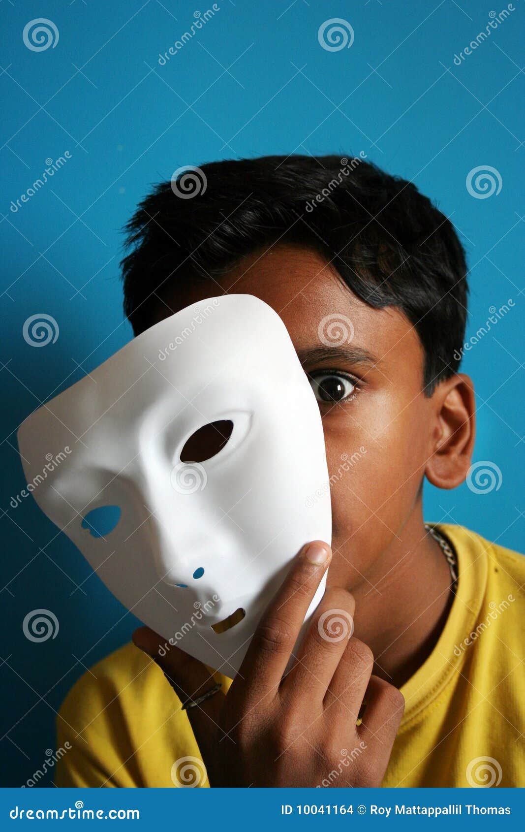 Boy removing the mask stock photo. Image of expression - 10041164