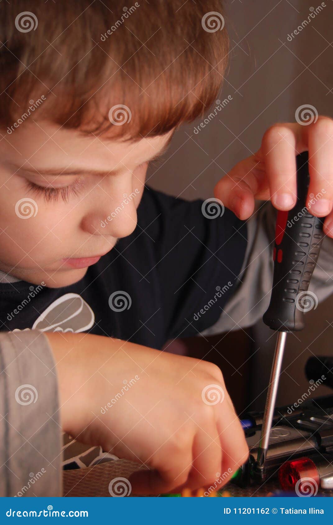 Boy repairing toys. stock photo. Image of serious, careful - 11201162