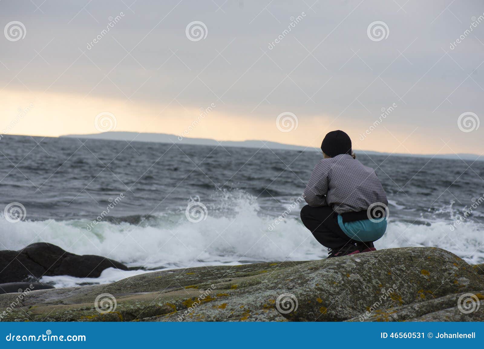 Boy Resting on Rock at Seaside Stock Image - Image of scenic, landscape ...