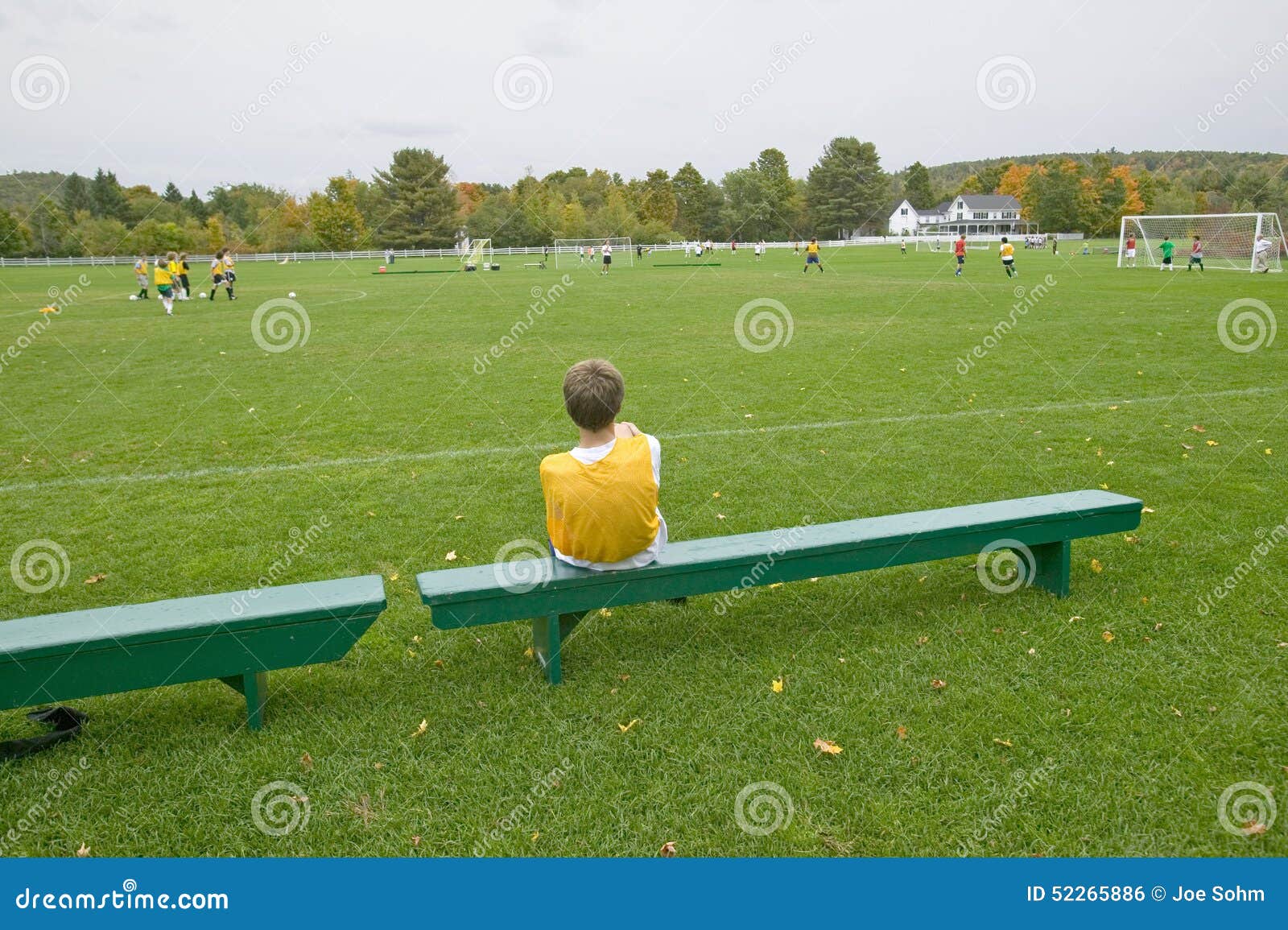 A Boy Rests on a Bench during School Soccer Practice, New Hampshire ...