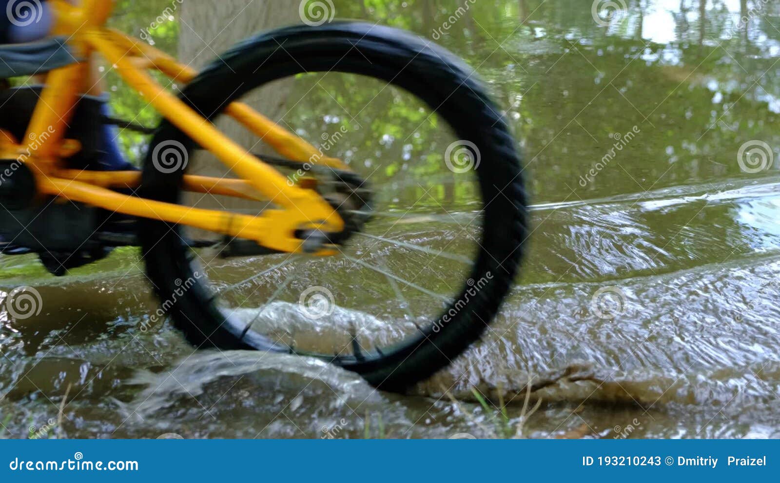 Boy Rides a Bicycle, Passing through a Puddle, in the Summer after the ...