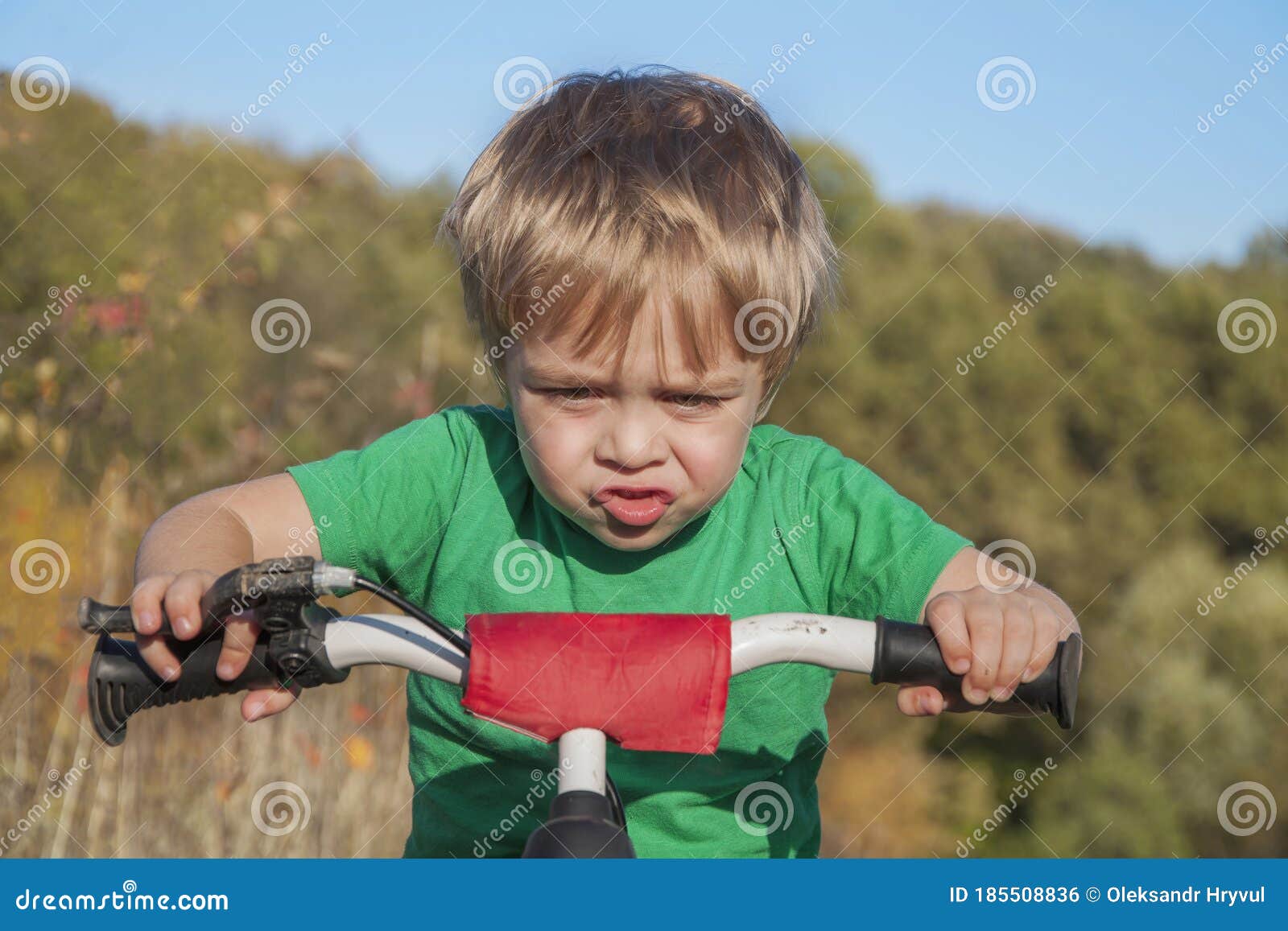 A Boy Rides A Bicycle. He Is Purposefully And Confidently Moving ...