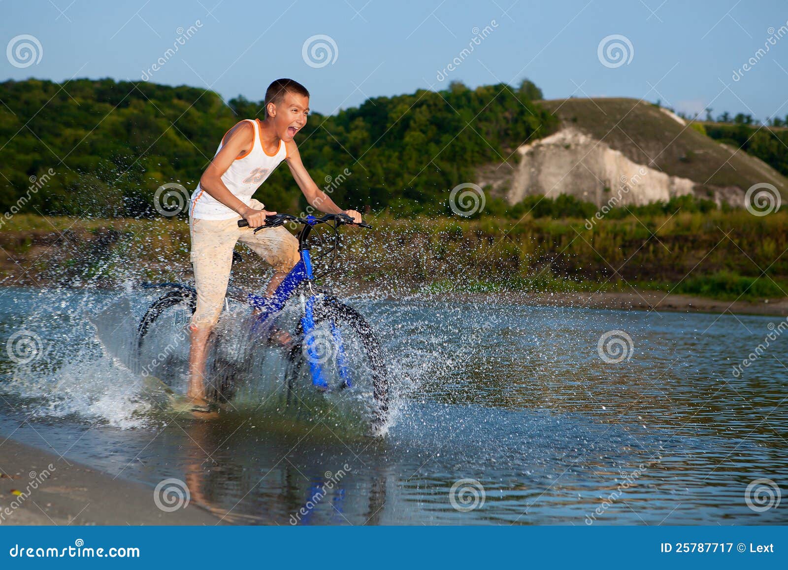 Boy Rides His Bike Along the River Stock Image - Image of spray, travel: 25787717