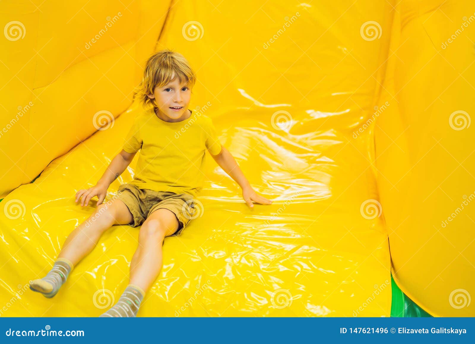 The Boy Rides with an Inflatable Slide Stock Photo - Image of human ...