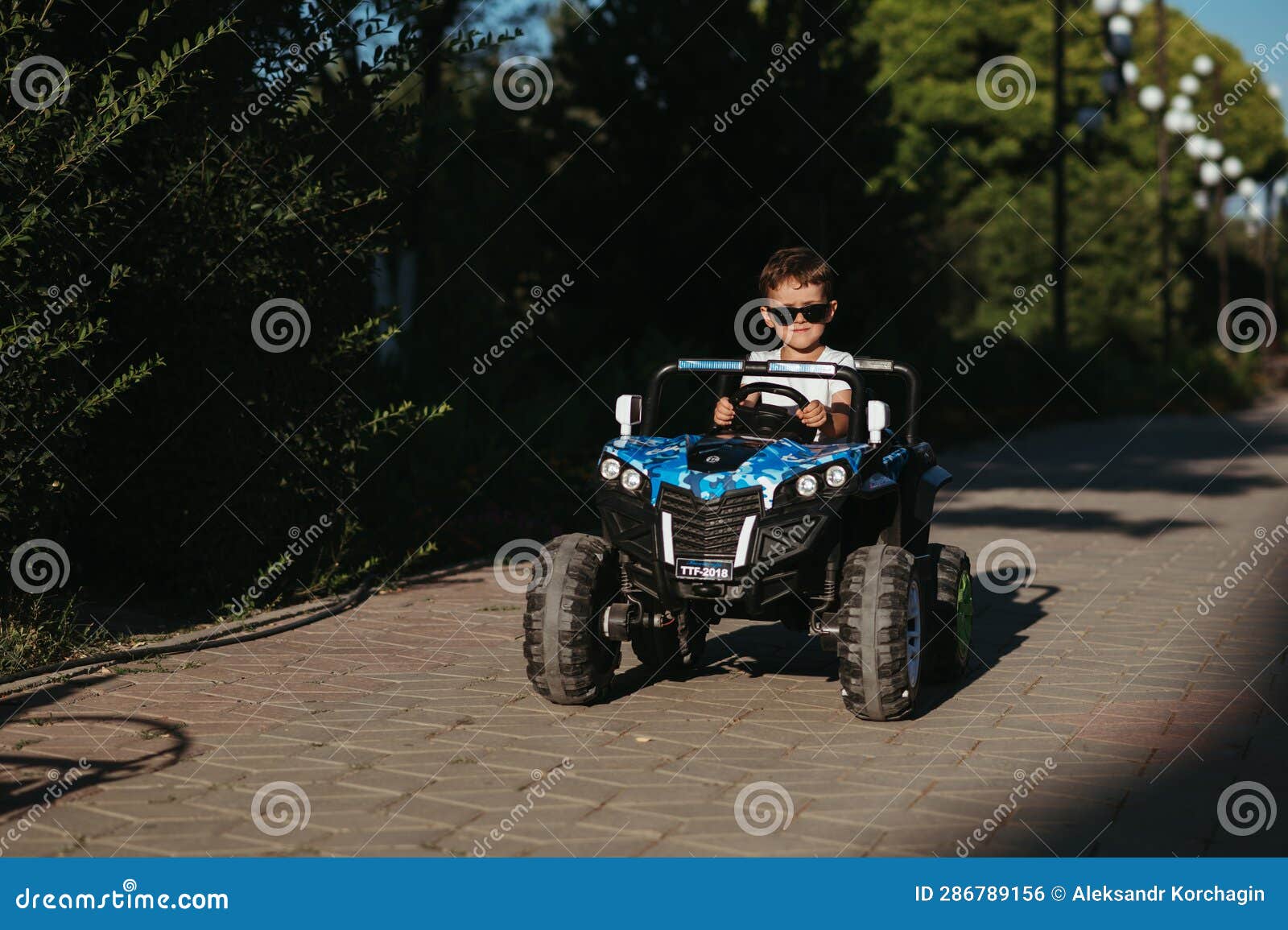 Boy Rides in Toy Mini Car in Park in Summer Stock Photo - Image of ...