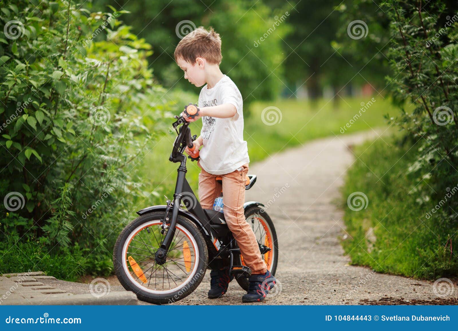 The boy is riding a bike stock image. Image of cheerful - 104844443