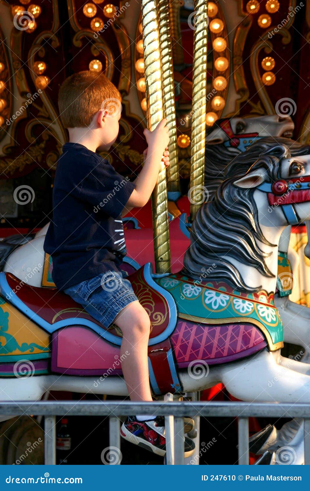 Boy Riding on Carousel stock photo. Image of game, lights - 247610