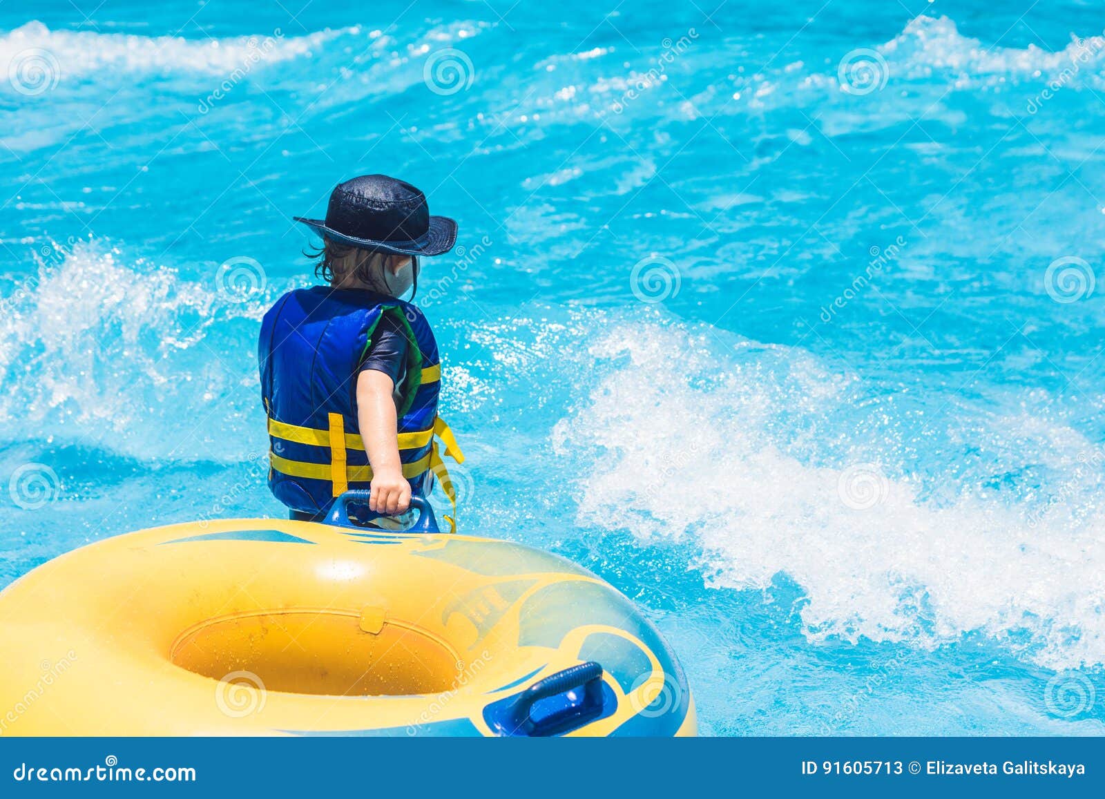 The Boy is Riding on an Inflatable Donut at a Water Park Stock Image ...