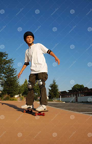 Boy Riding a Skateboard stock photo. Image of protection - 7449554