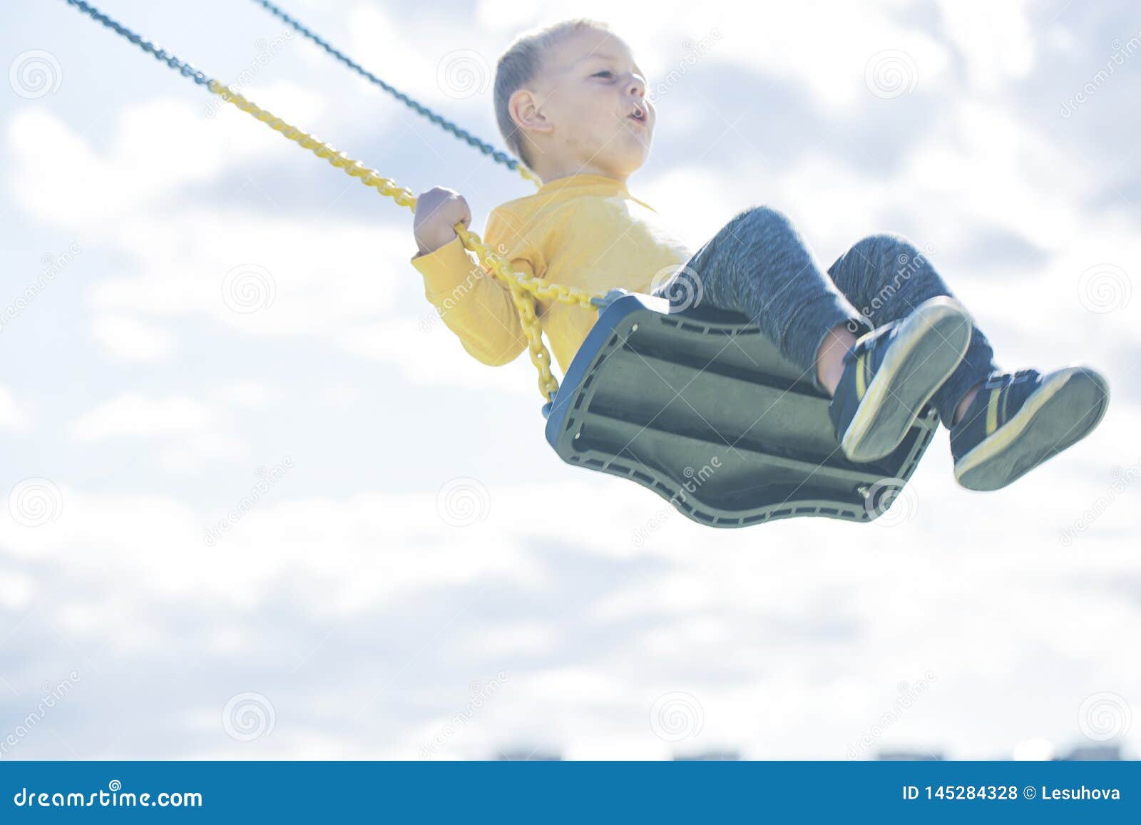 A boy is riding a swing stock photo. Image of freedom - 145284328