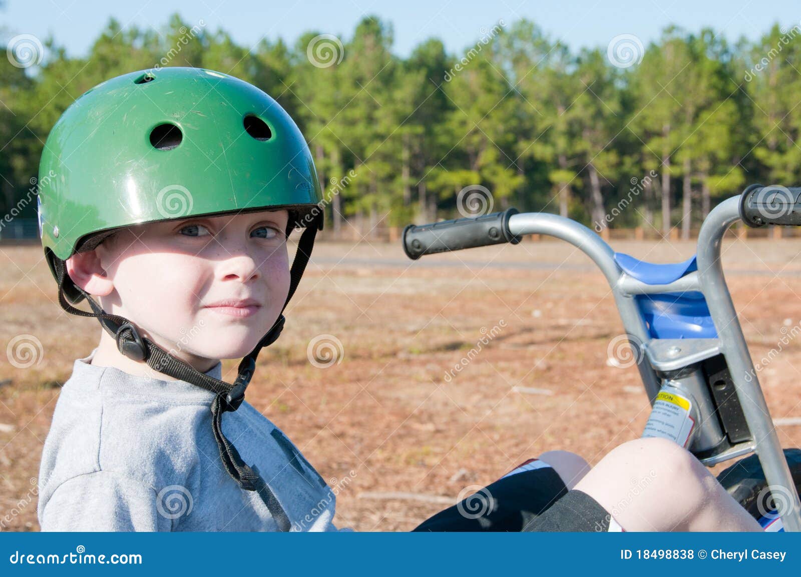 Boy riding trike stock photo. Image of trike, proection - 18498838