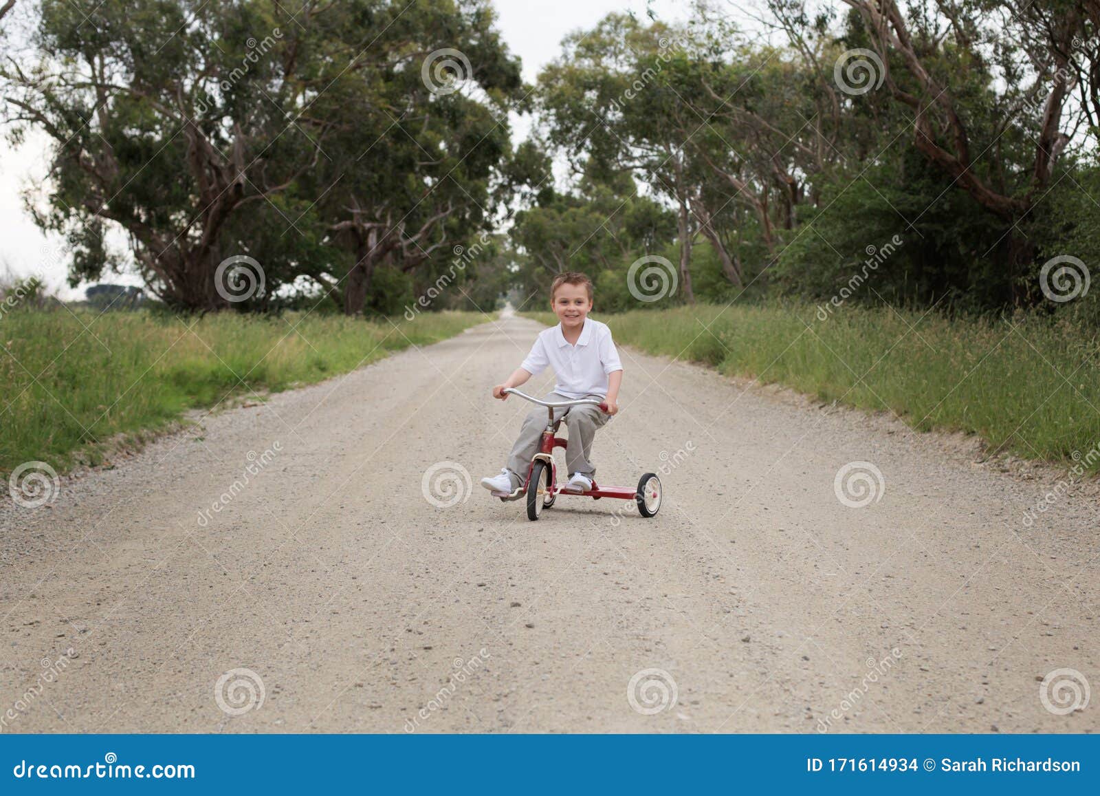 Boy Riding a Tricycle on a Dirt Road Stock Photo - Image of active ...