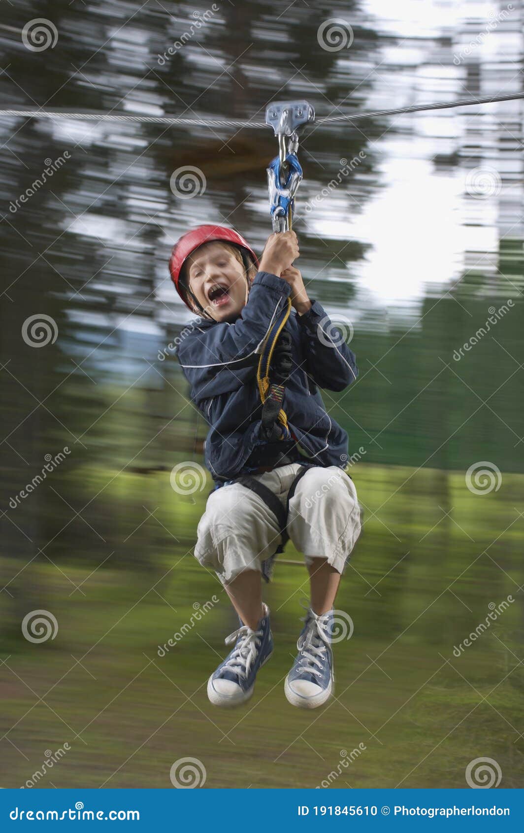 Boy (7-9) Riding Zip-line in Forest Stock Photo - Image of line ...