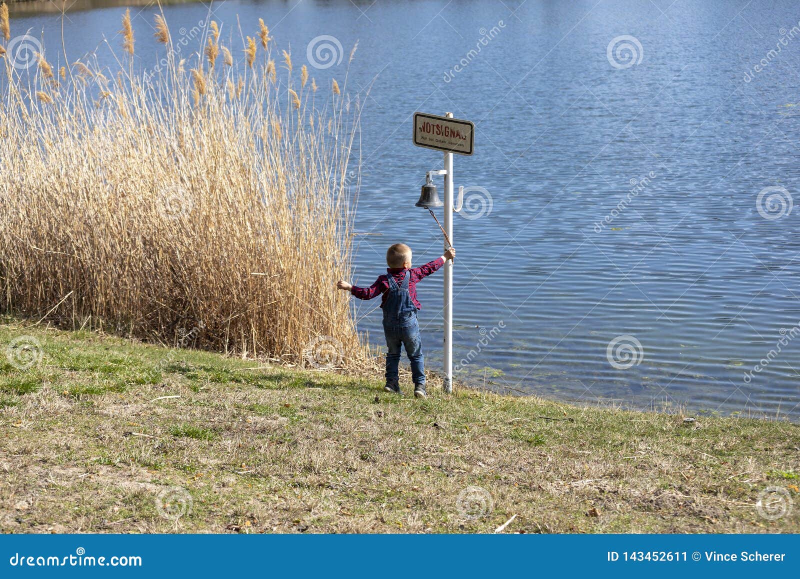 Boy Ringing In Blue Bell At Sunset In The Park Royalty-Free Stock Photo ...