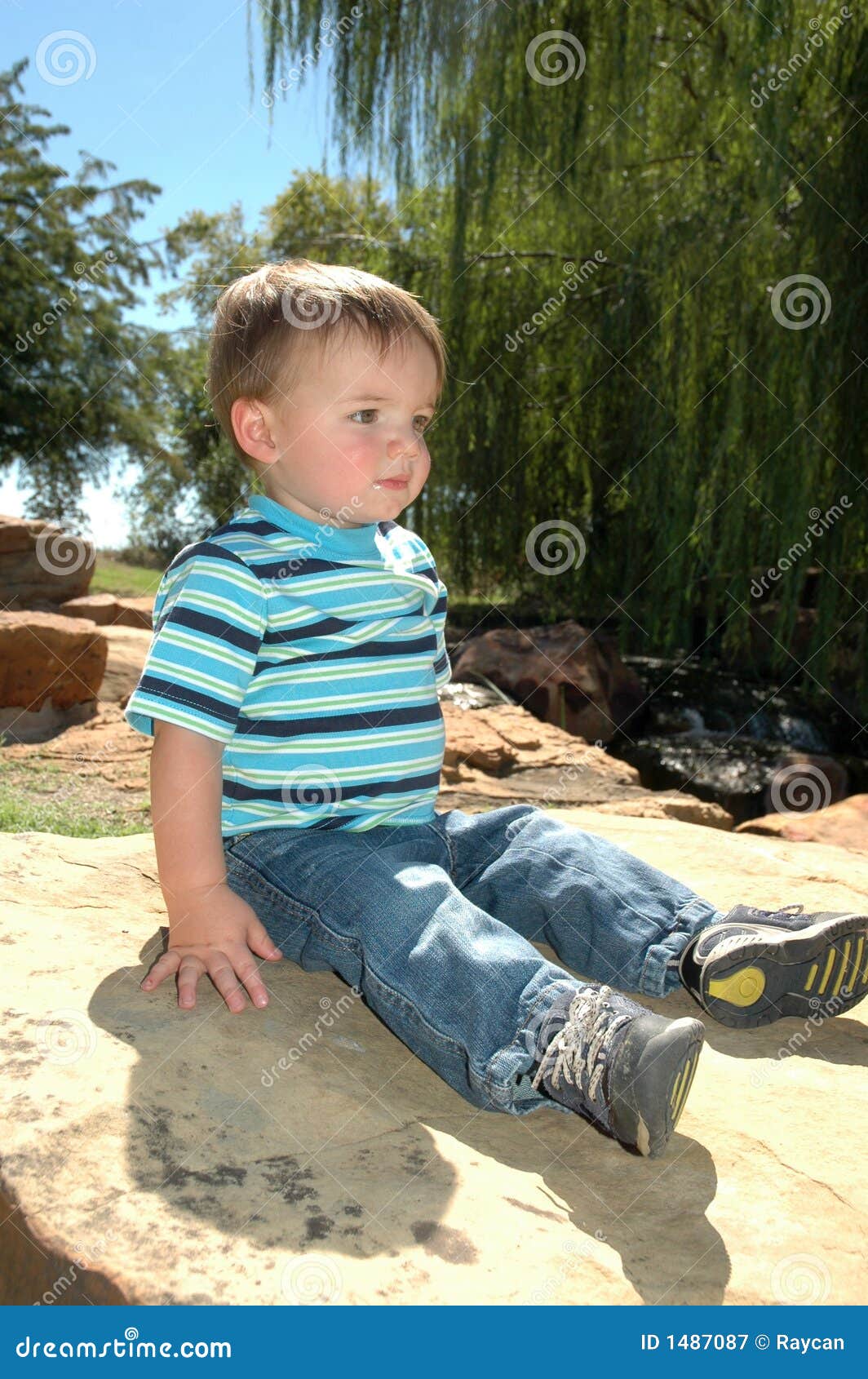 Boy on Rock stock image. Image of making, face, handsome - 1487087
