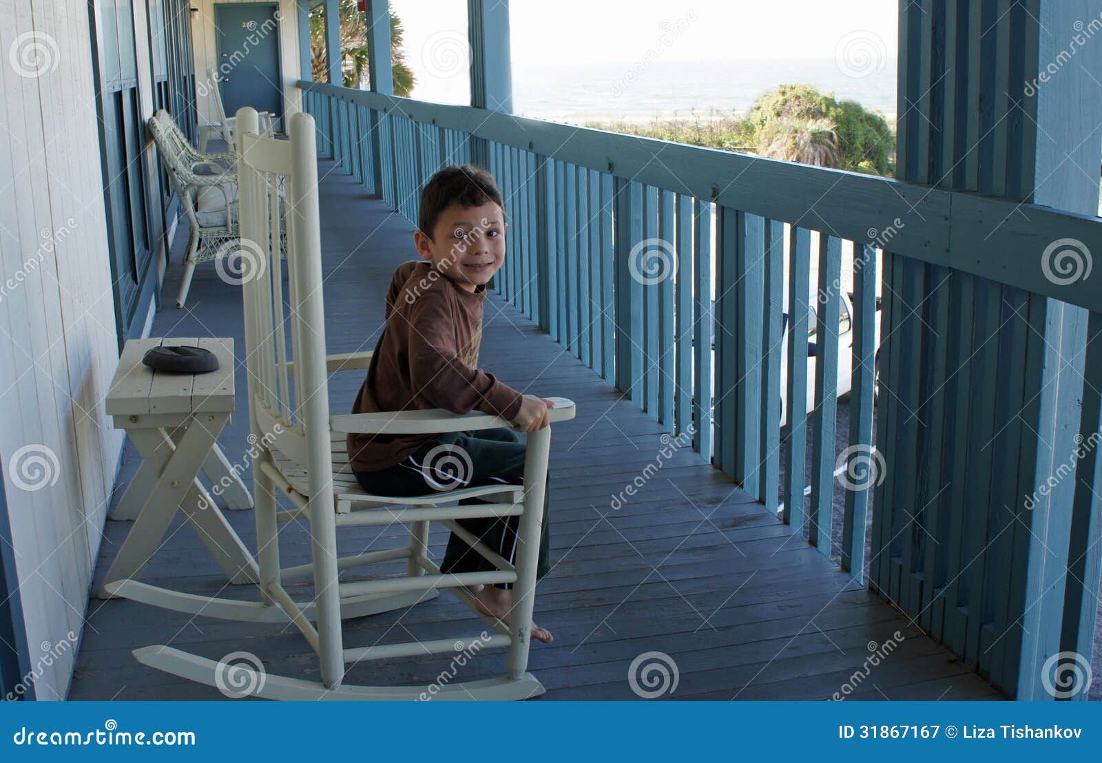 Boy on rocking chair stock image. Image of human, eyes - 31867167