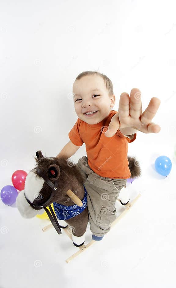 Boy and rocking horse stock image. Image of little, happinnes - 22056373