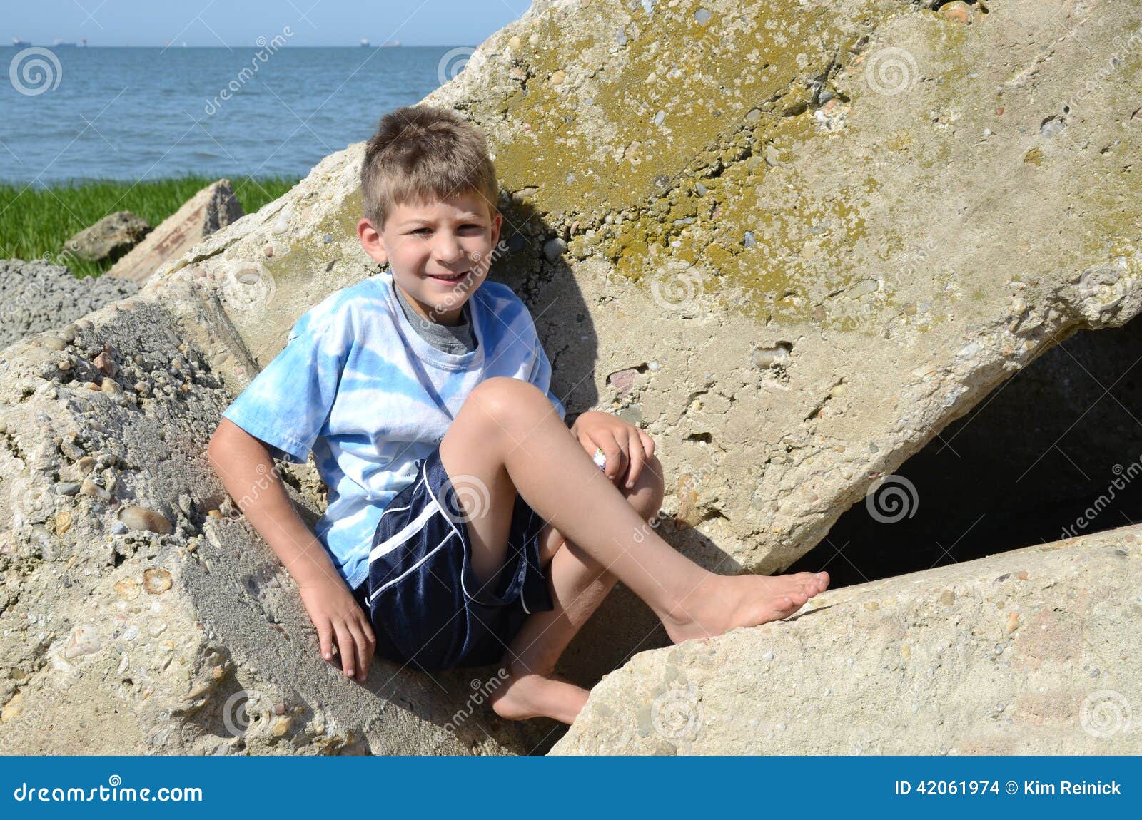 Boy on Rocks stock photo. Image of young, rocks, water - 42061974