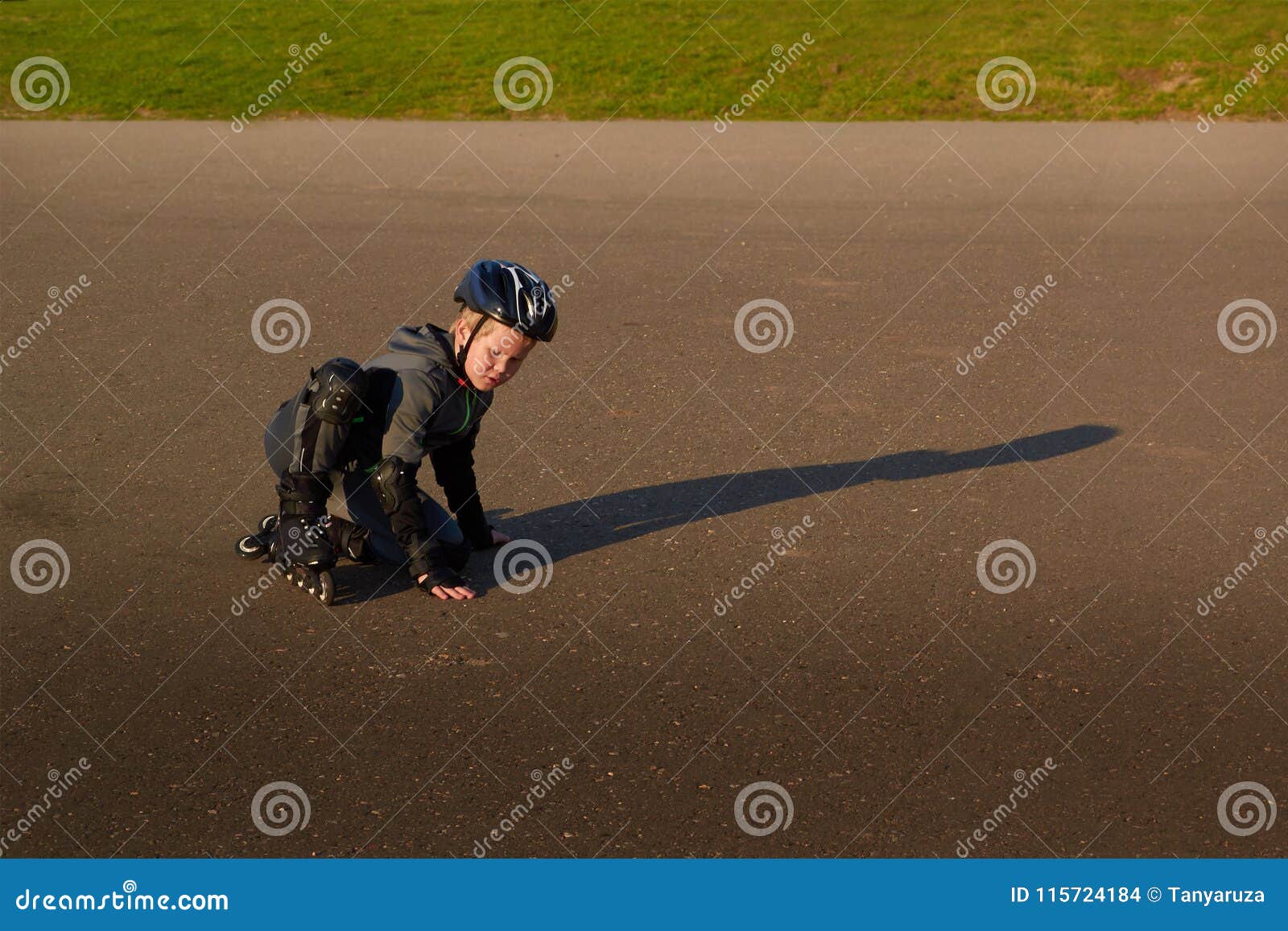 Boy on Roller Skates Gets Up after Falling Stock Photo - Image of ...