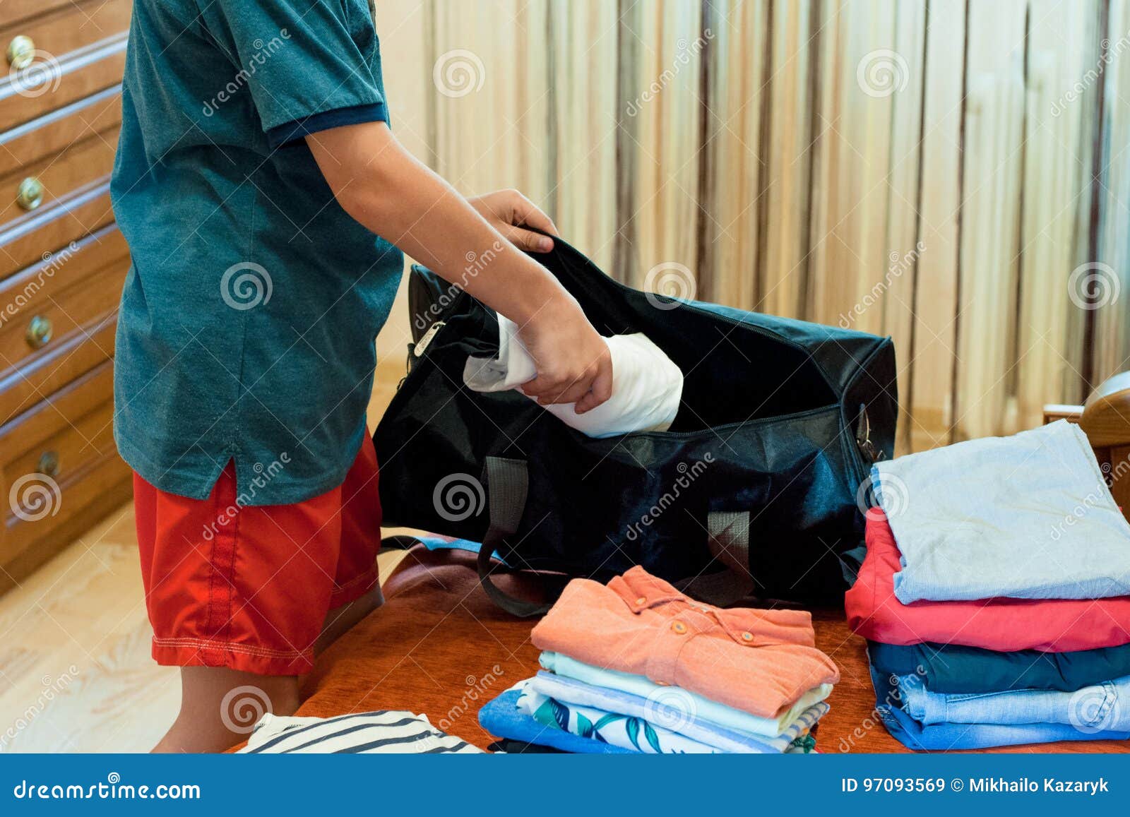 The Boy in the Room Collects His Clothes in a Bag Stock Image - Image ...