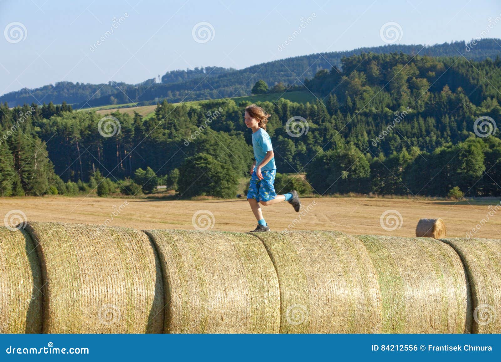 Boy Running on Bales of Hay Stock Photo - Image of child, nature: 84212556
