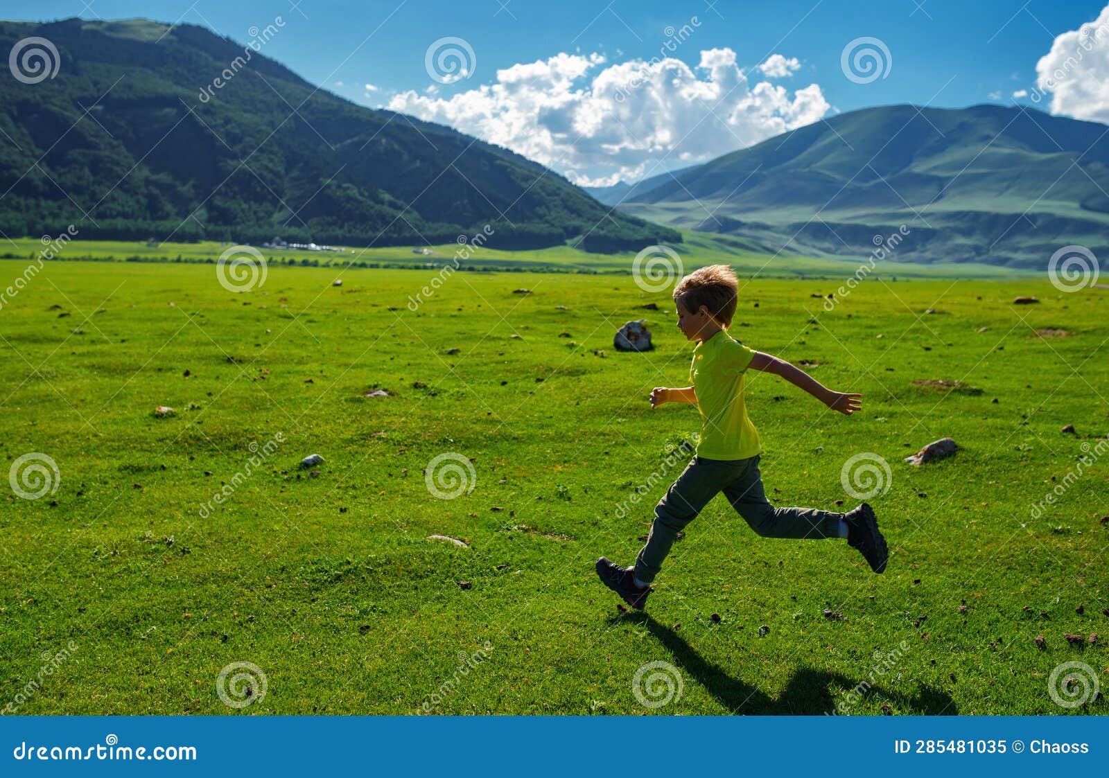 Boy Running Fast on a Green Meadow in the Mountains Stock Image - Image ...
