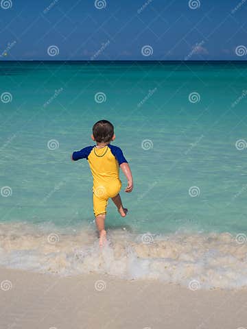 Boy running into ocean stock image. Image of running - 47106745