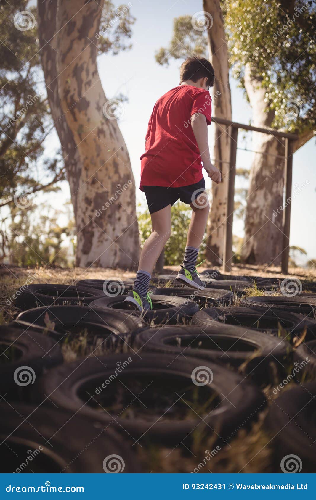 Boy Running Over Tyres during Obstacle Course Stock Image - Image of ...