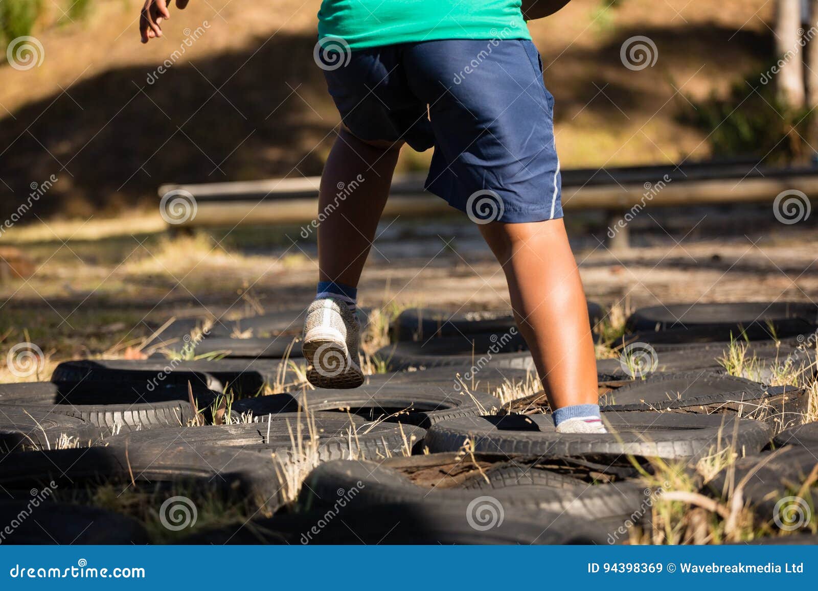 Boy Running Over Tyres during Obstacle Course Training Stock Image ...
