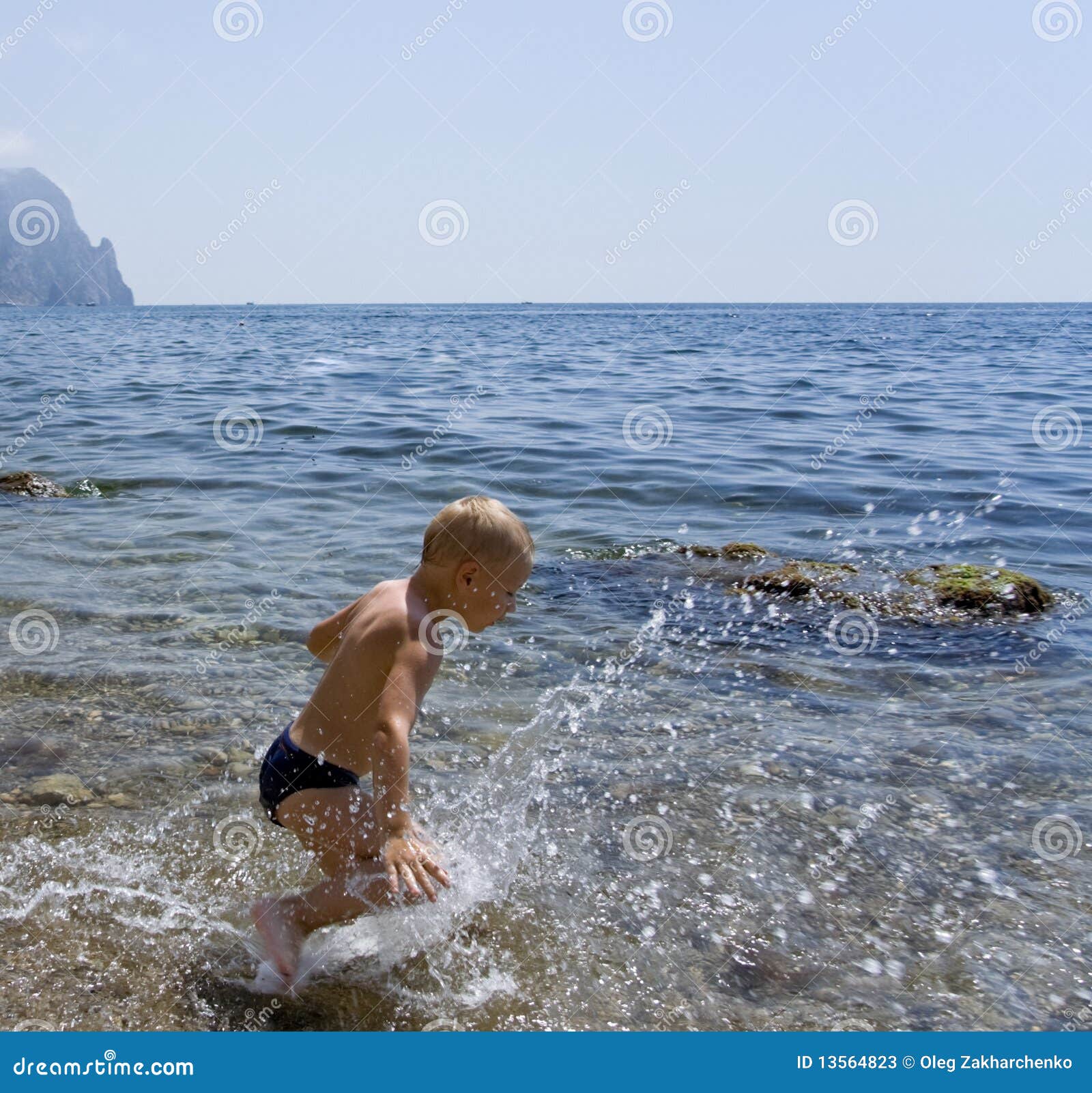 Boy running into the sea stock image. Image of sunlight - 13564823