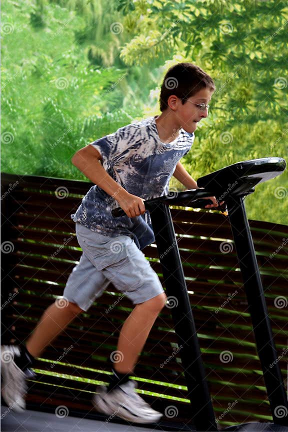 Boy running on treadmill stock image. Image of activity - 7418625