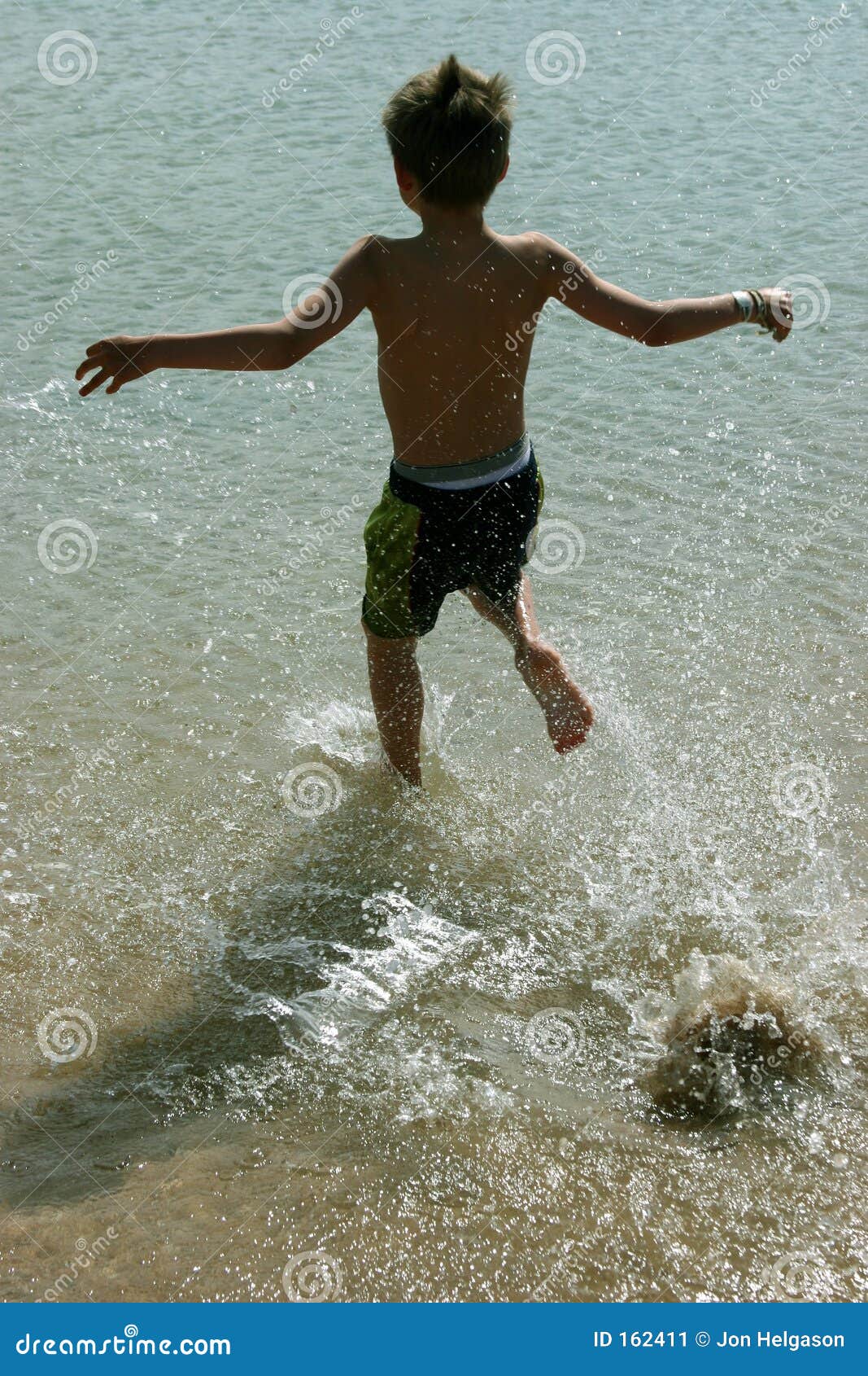 Boy running into the water stock image. Image of splash - 162411