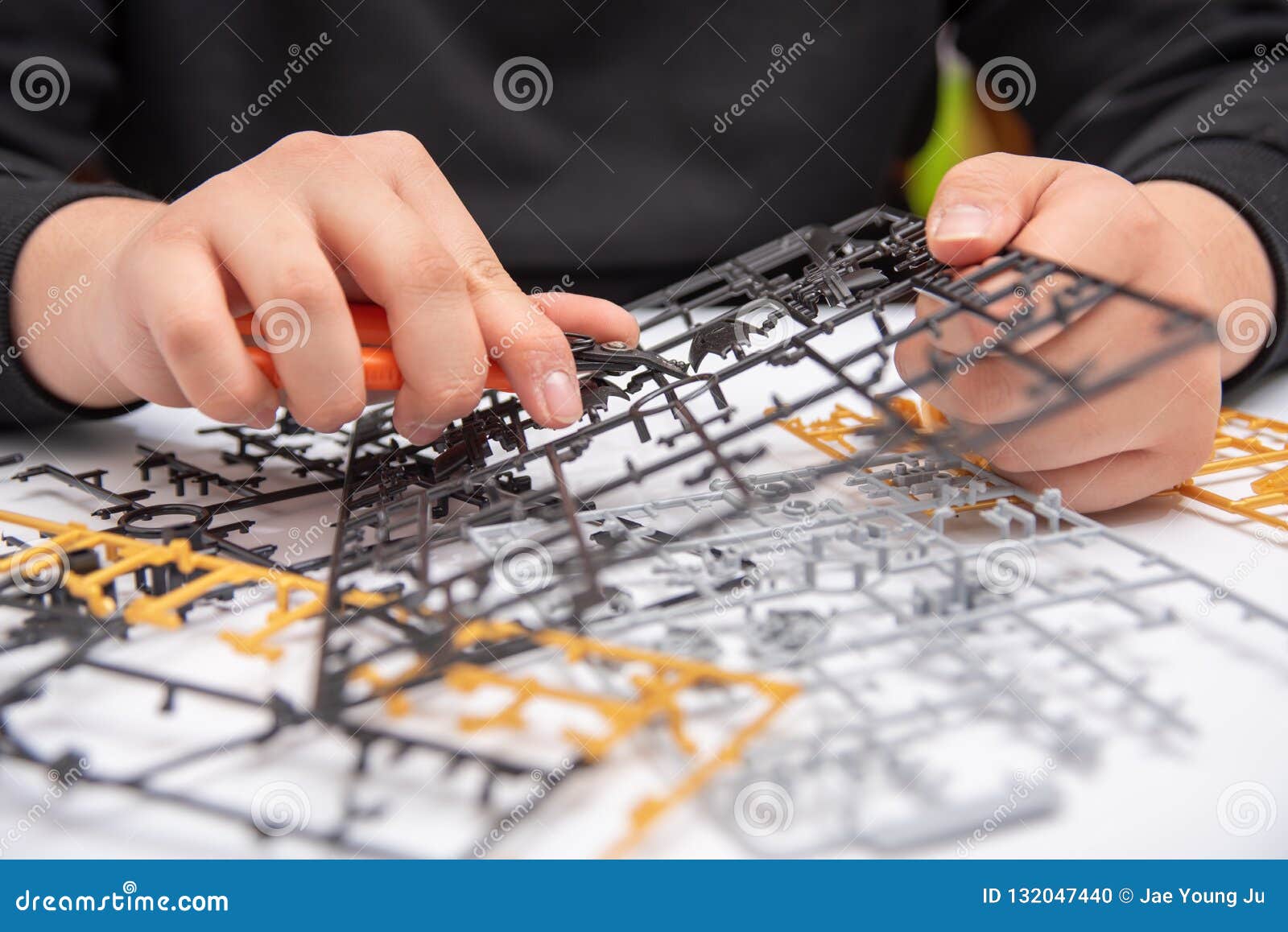 A Boy`s Hand Assembling Plastic Models Using Tools. Stock Photo - Image ...