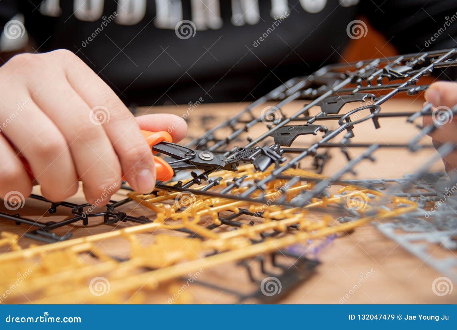 A Boy`s Hand Assembling Plastic Models Using Tools. Stock Image - Image ...