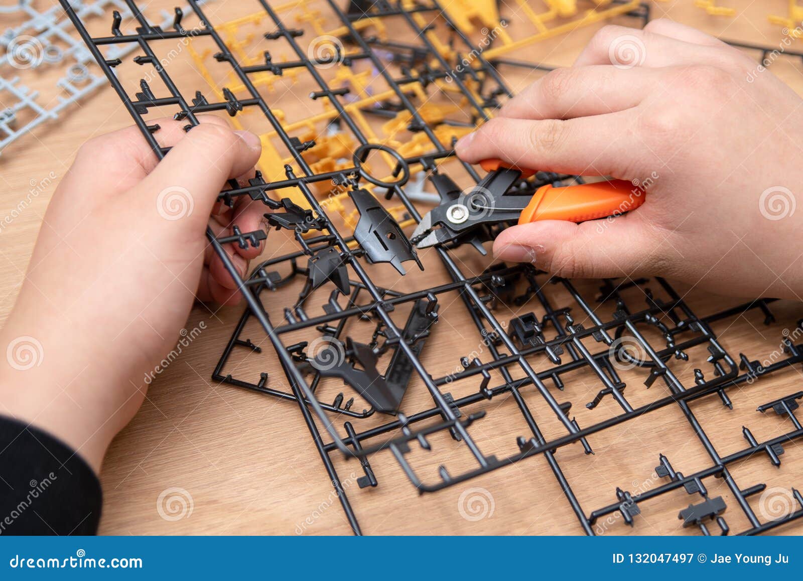 A Boy`s Hand Assembling Plastic Models Using Tools. Stock Image - Image ...