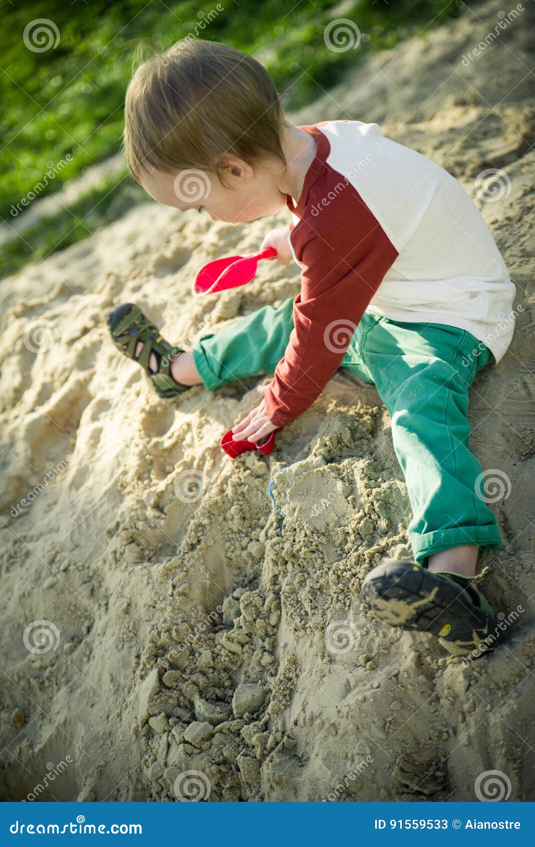 Boy and sand stock image. Image of jeans, green, kids - 91559533