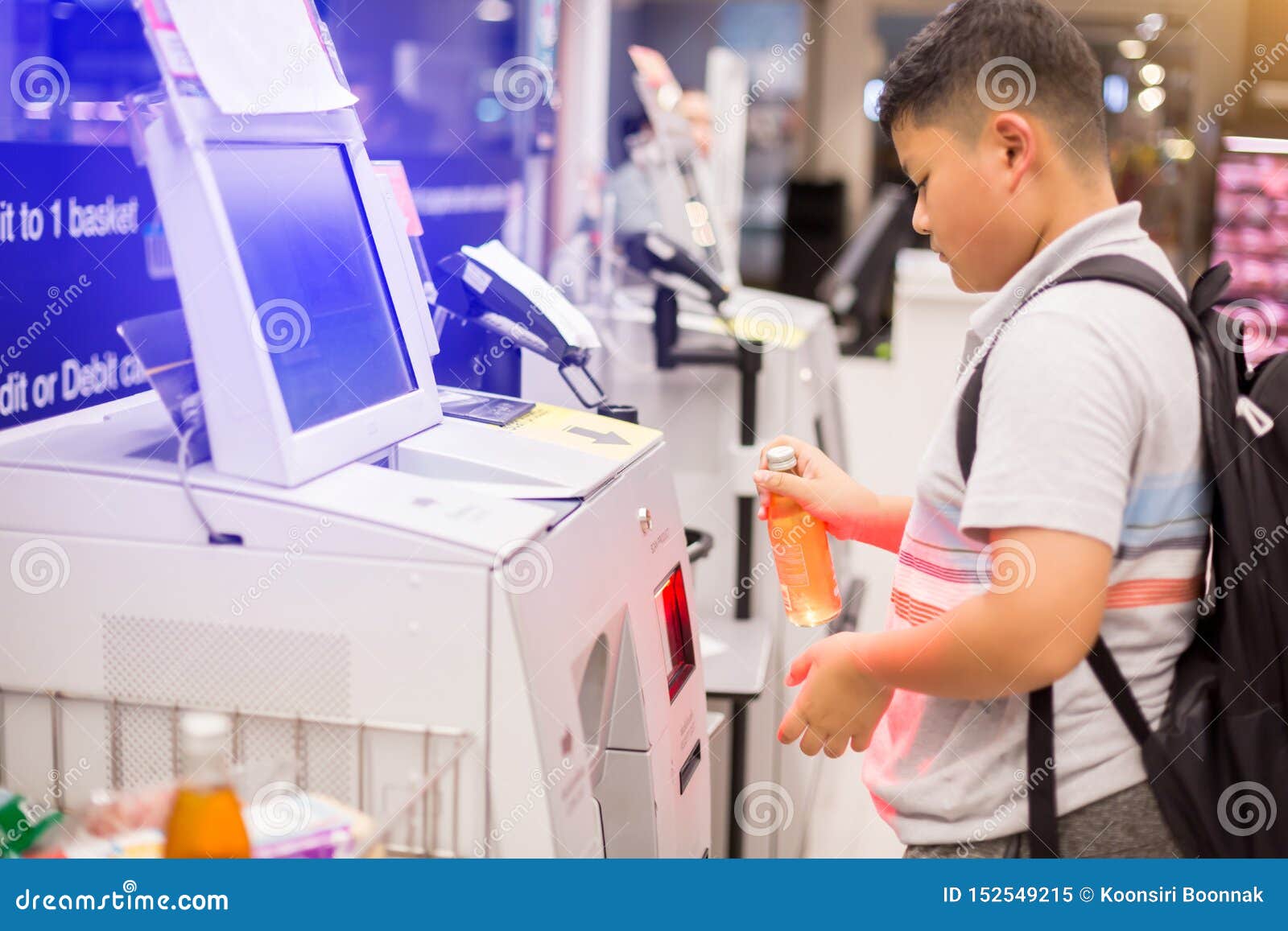 The Boy is Scanning the Product at the Automatic Payment Machine. Stock ...