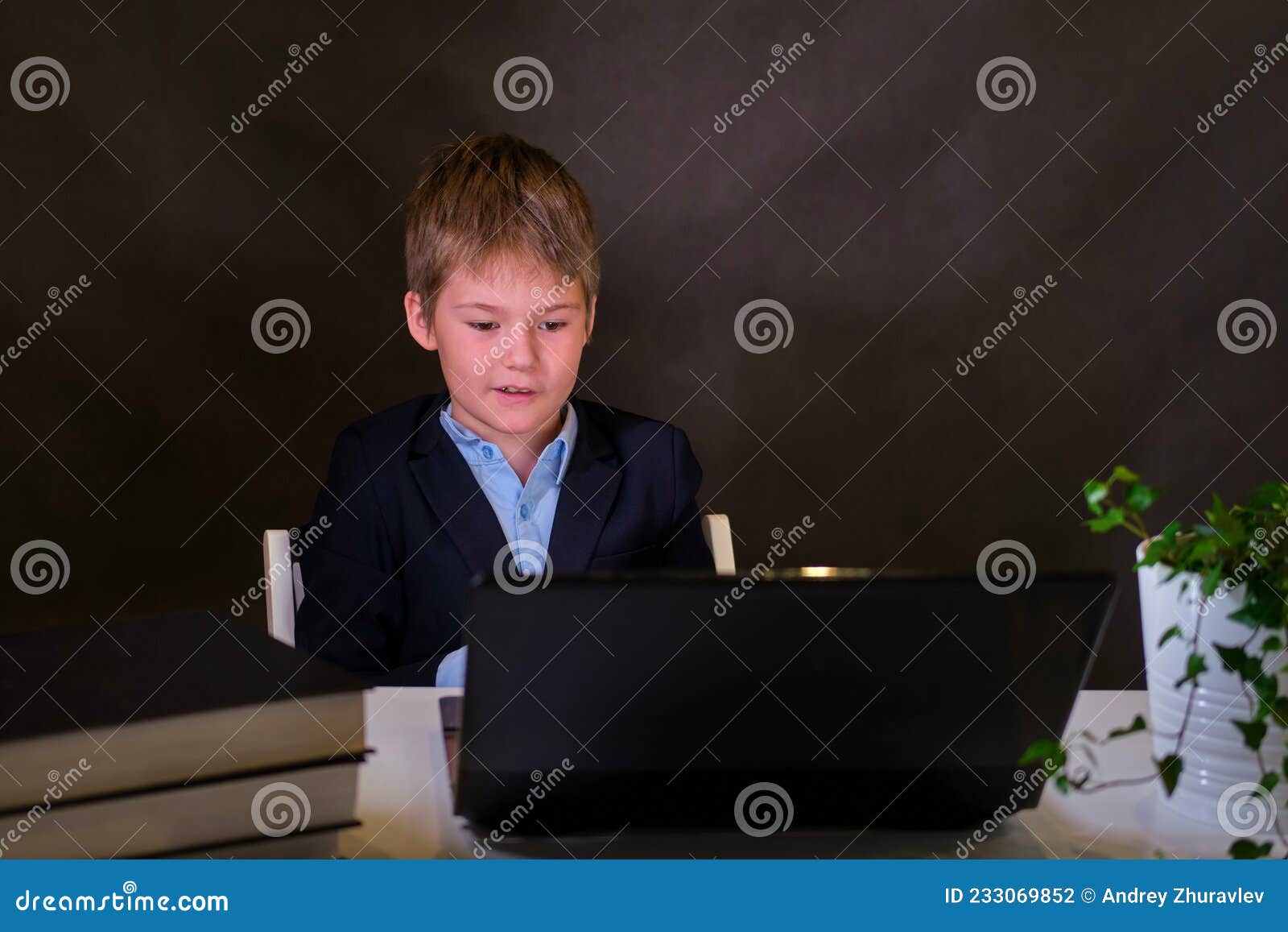 A Boy in a School Uniform at a Computer, Copy Space on a Dark Studio ...