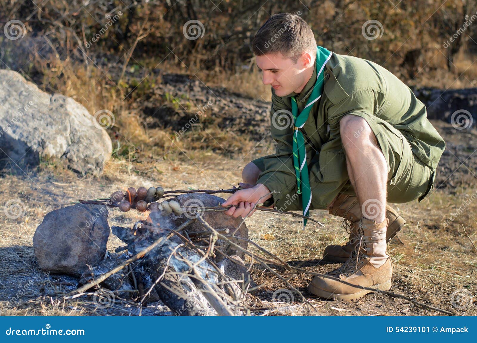 Boy Scout Cooking Sausages on Sticks Over Campfire Stock Image - Image ...