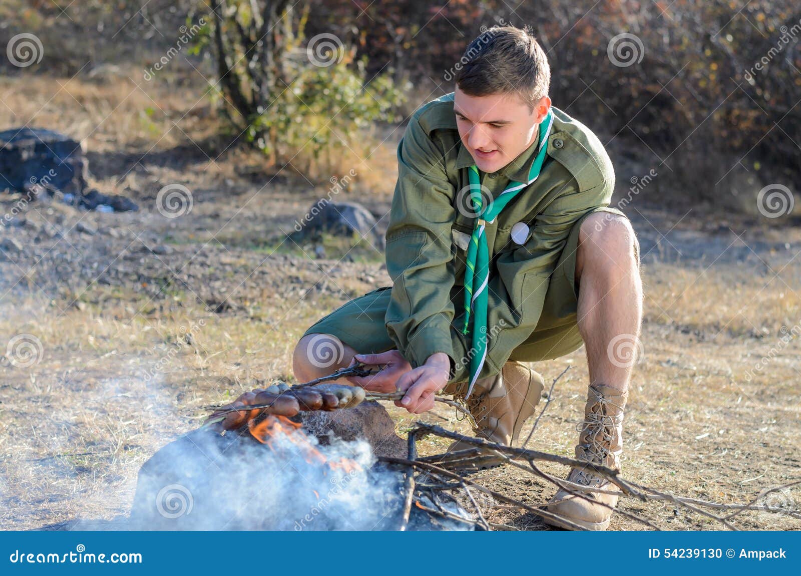 Boy Scout Cooking Sausages on Sticks Over Campfire Stock Photo - Image ...