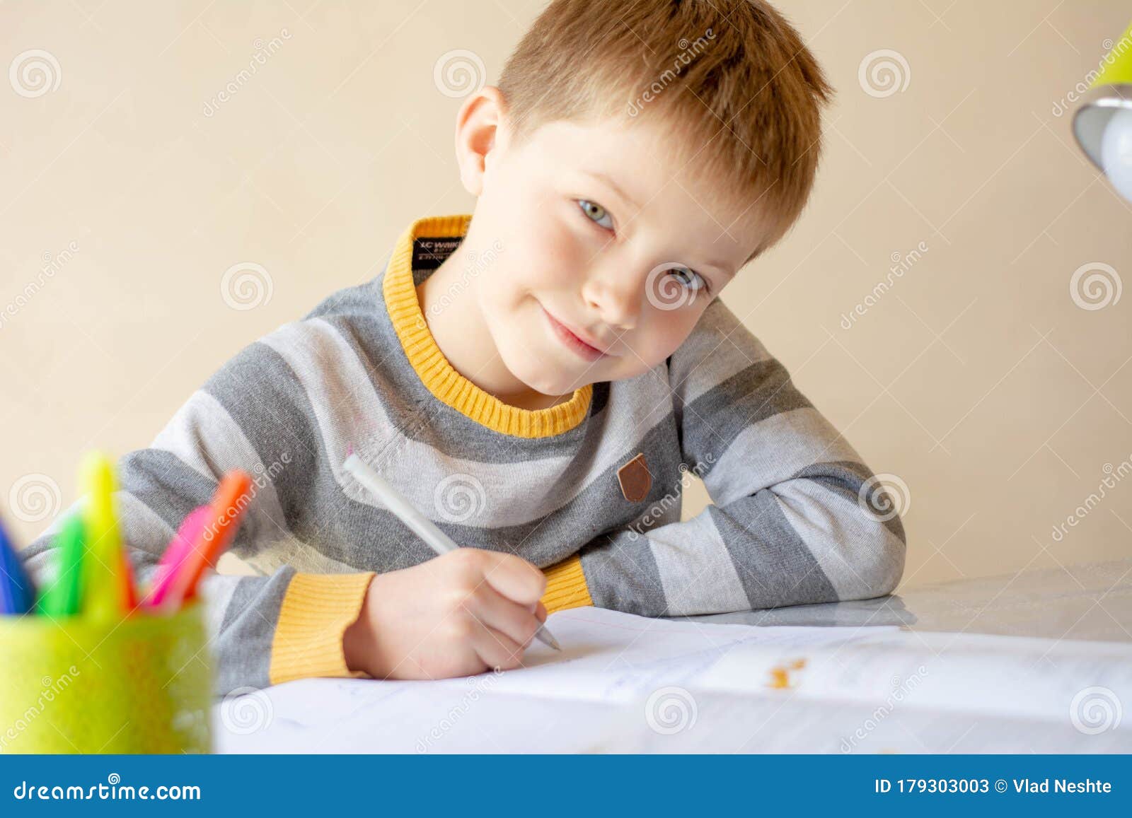 The Boy Does His Homework. the Child is Learning Remotely. a Boy Sits ...