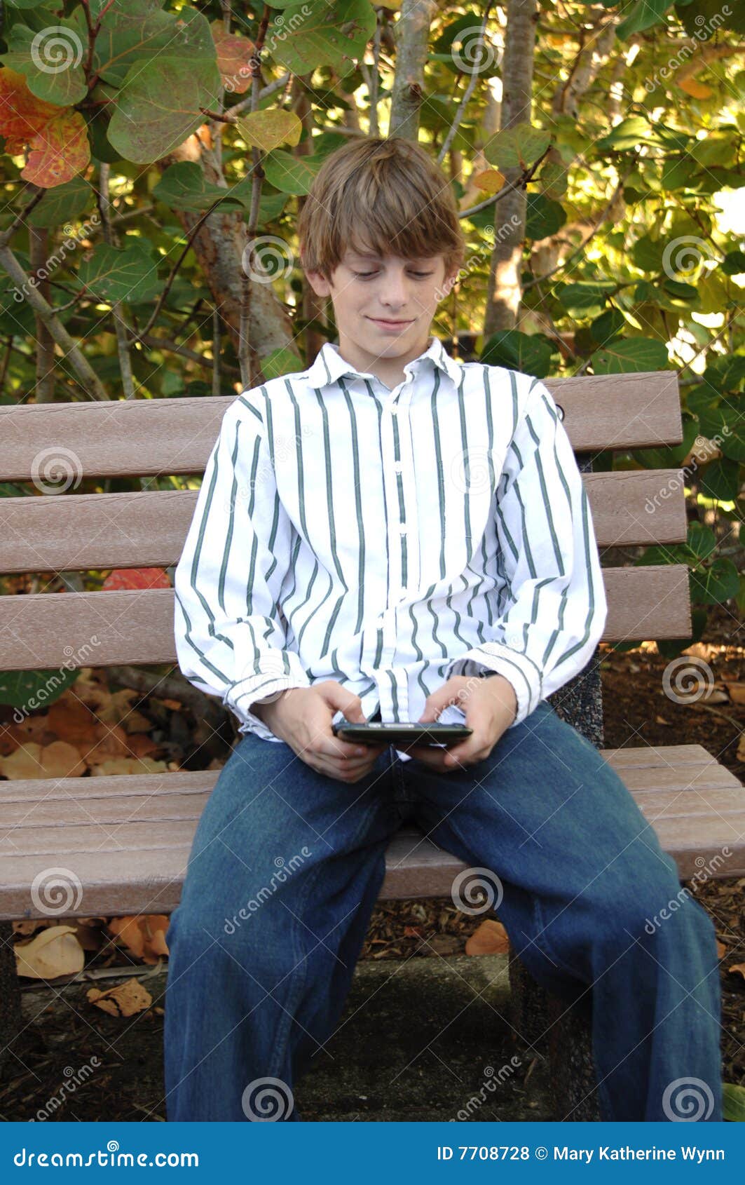 Boy sending text message stock photo. Image of outdoors - 7708728