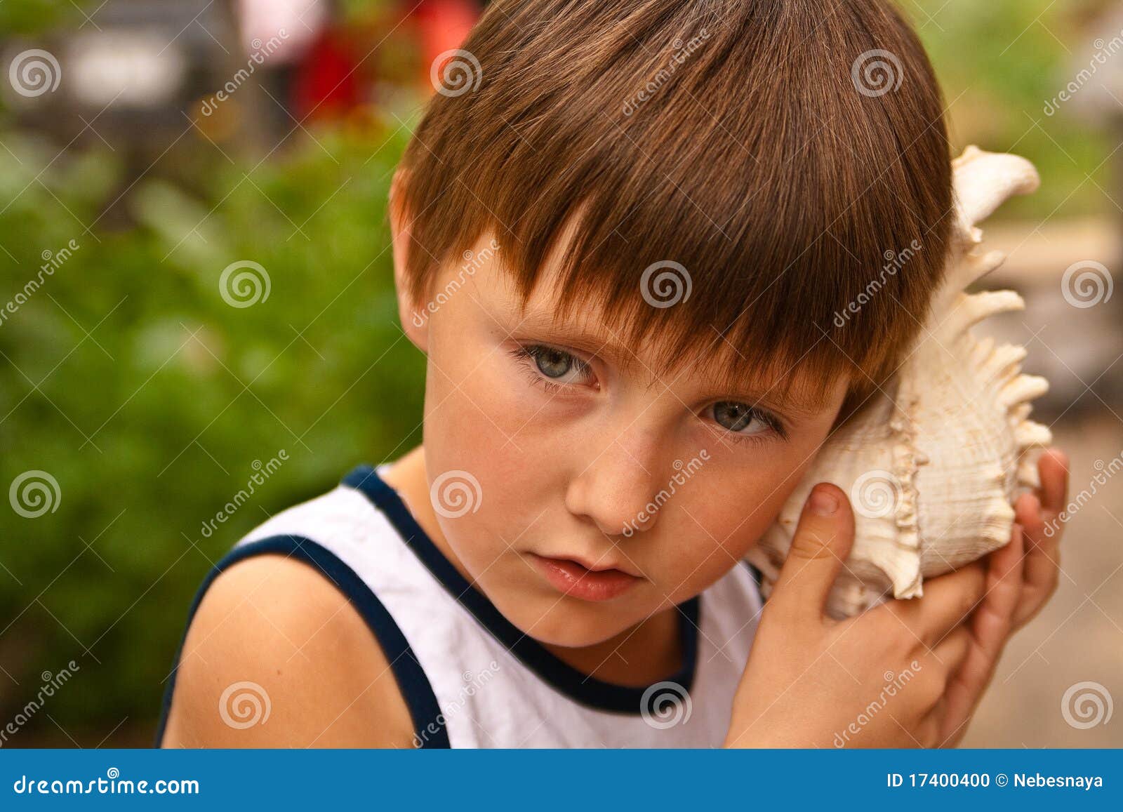 Boy with a shell stock photo. Image of listening, shell - 17400400