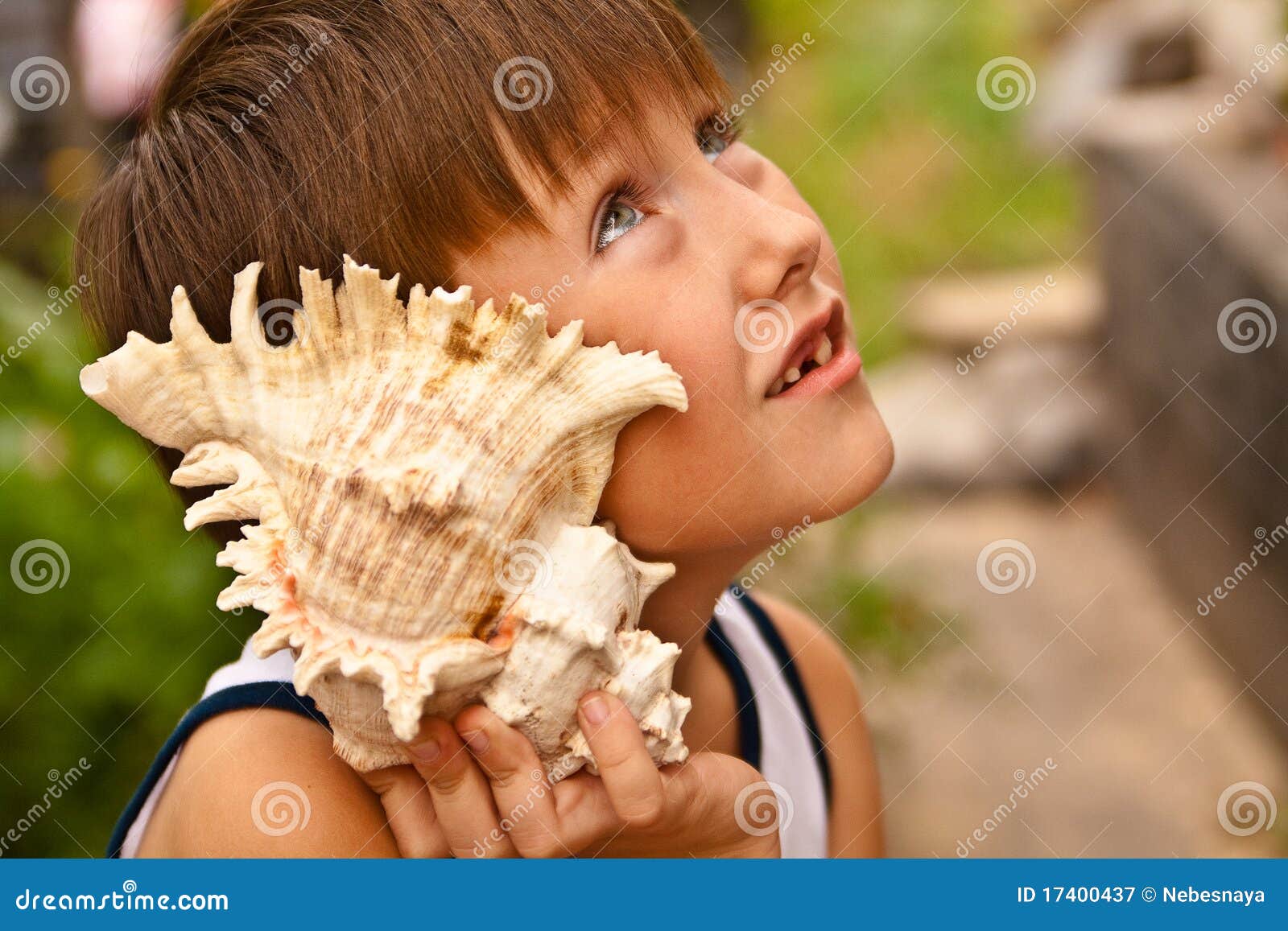 Boy with a shell stock image. Image of expressive, portrait - 17400437